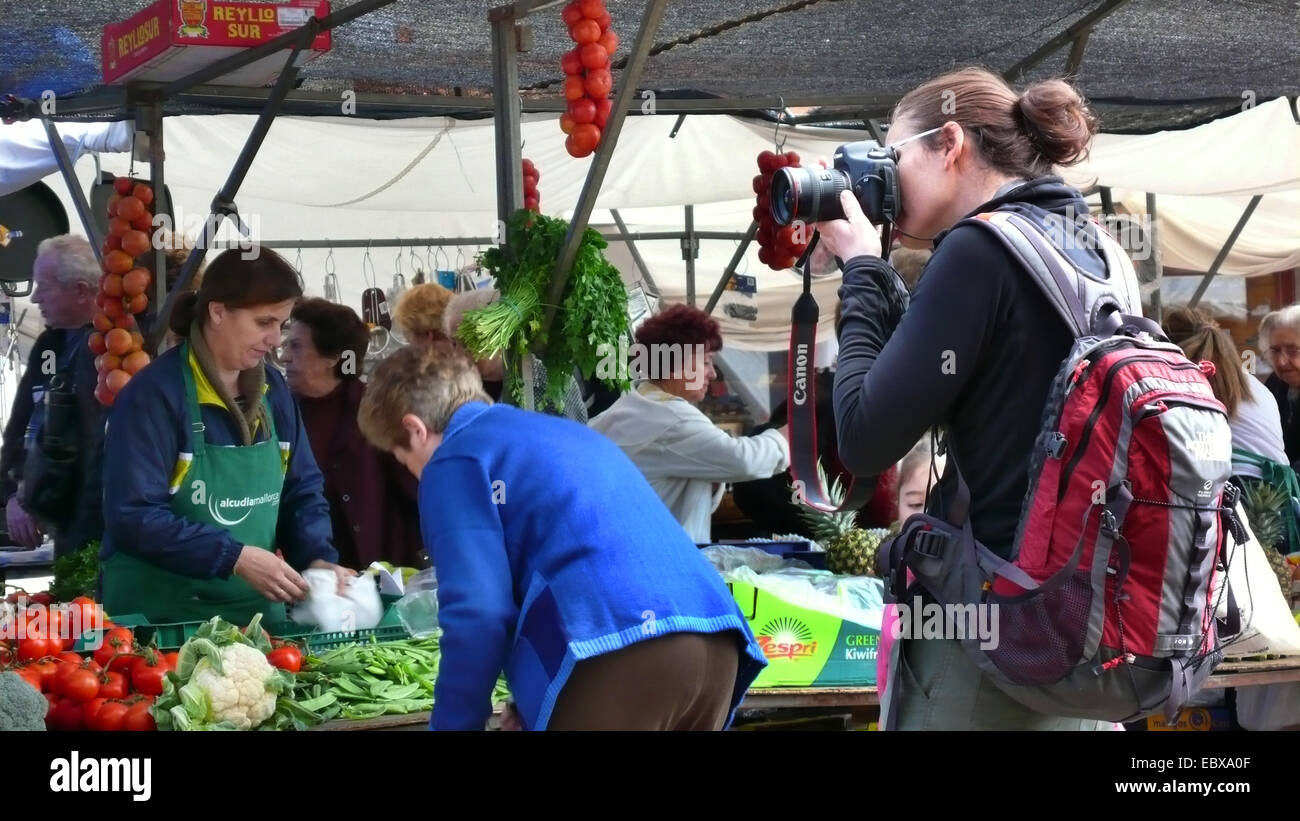 female photograper taking pictures on an open market, Spain, Balearen ...