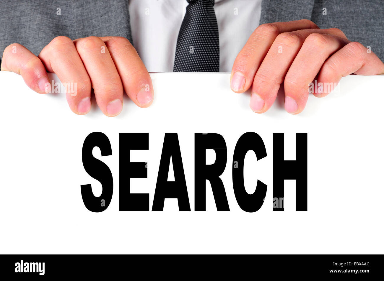 a man wearing a suit holding a signboard with the word search written ...
