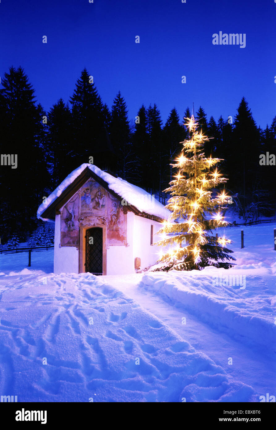 chapel in winter and a lighting christmas tree at night Stock Photo - Alamy