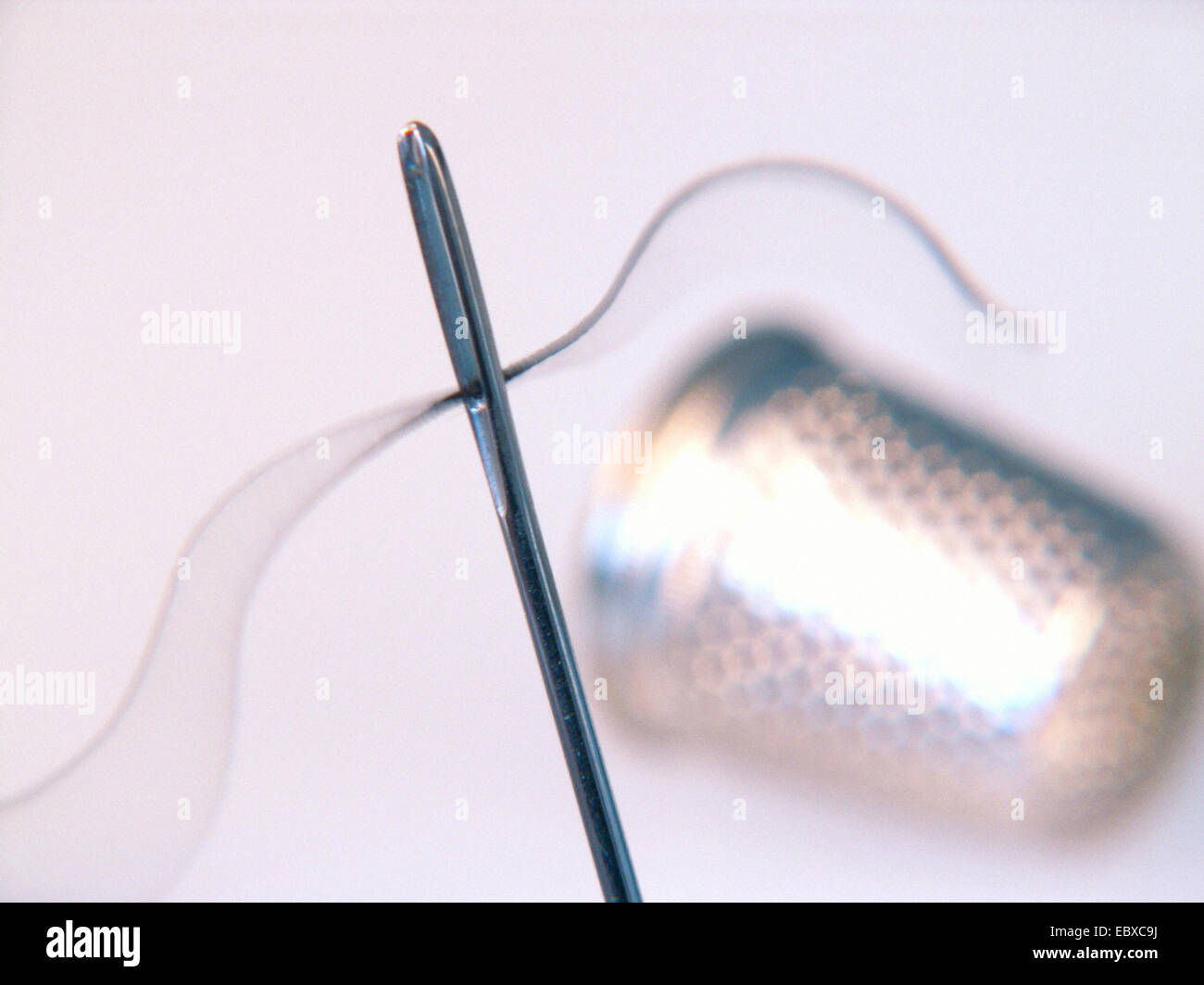 needle with twine and thimble Stock Photo - Alamy