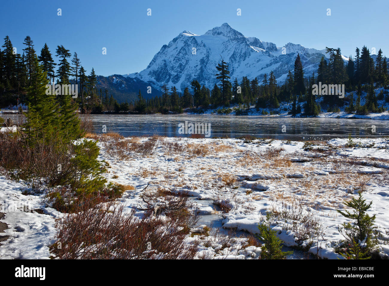 Winter scene of Mount Shuksan and Picture lake frozen over with ice on ...