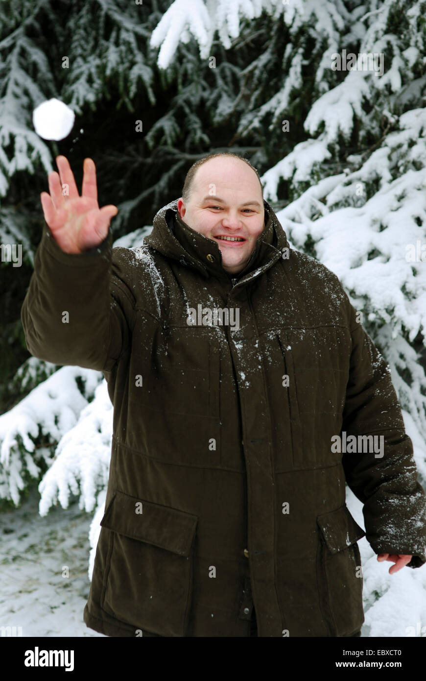 man throwing a snowball Stock Photo - Alamy