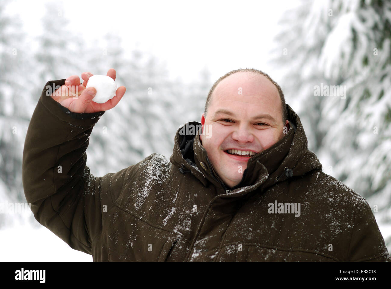 man throwing a snowball Stock Photo - Alamy