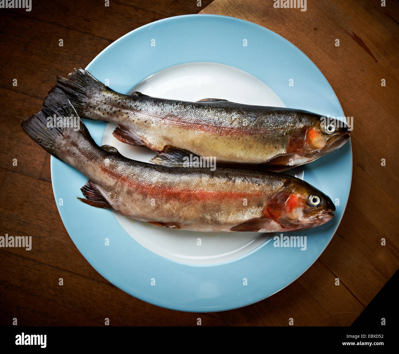 Two trout on a plate ready for cooking Stock Photo - Alamy