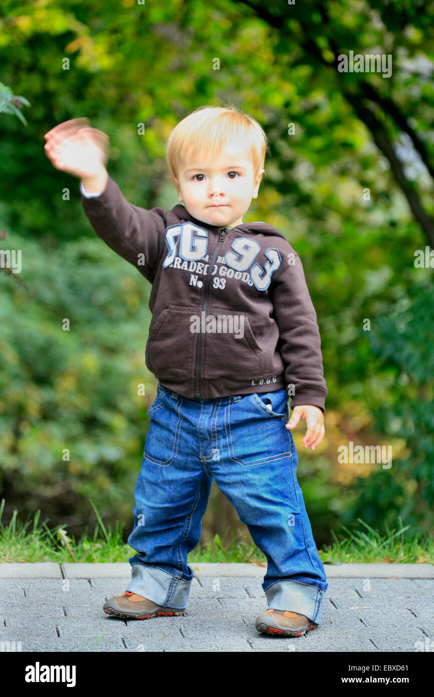 little boy waving into the camera Stock Photo - Alamy