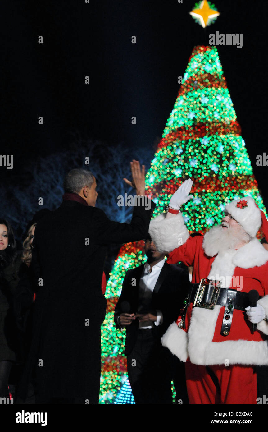US President Barack Obama greets Santa Claus with a high five during ...
