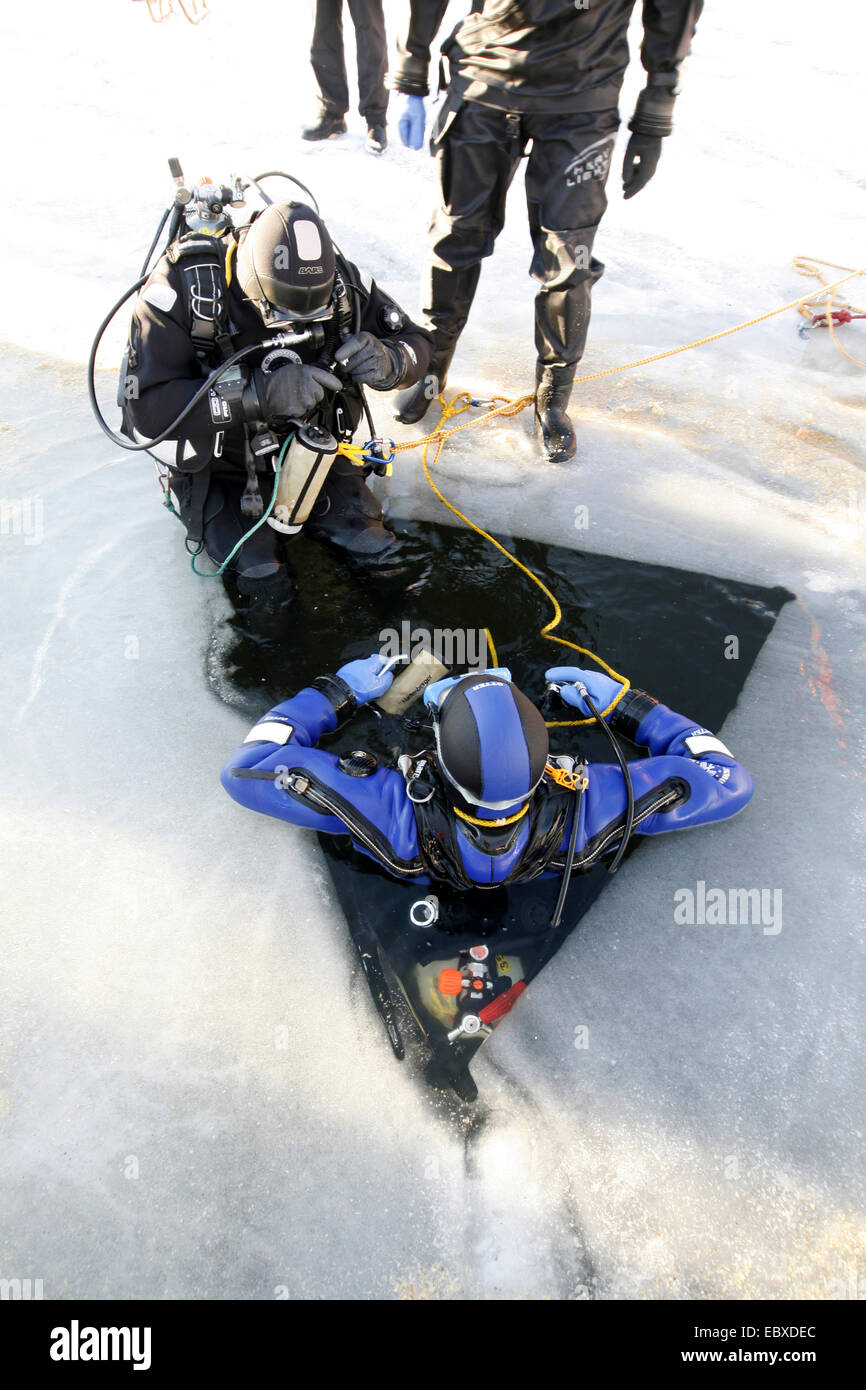 ice diver preparing to dive into frozen lake, Germany, North Rhine ...