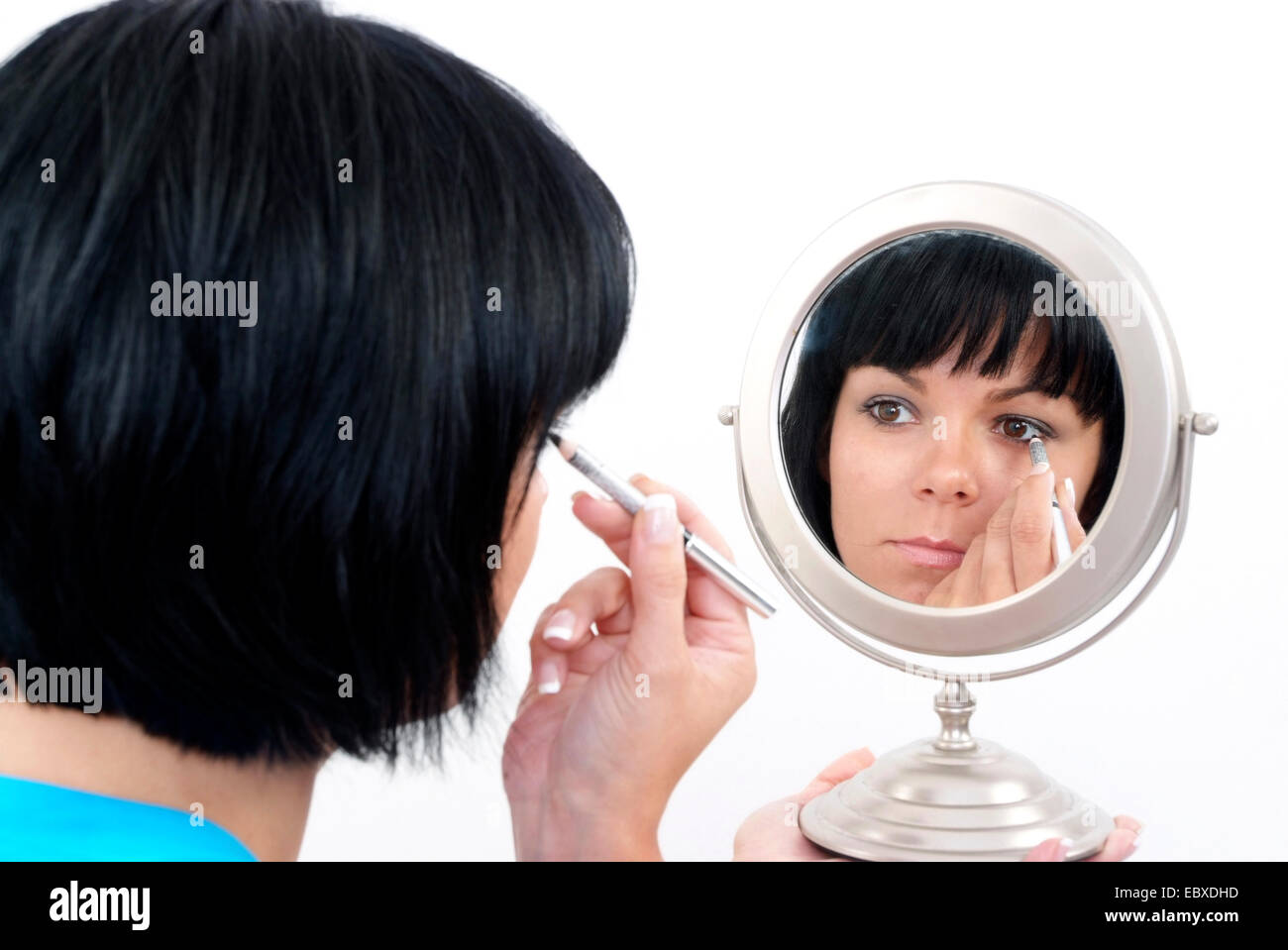 woman with makeup mirror, painting her face Stock Photo - Alamy