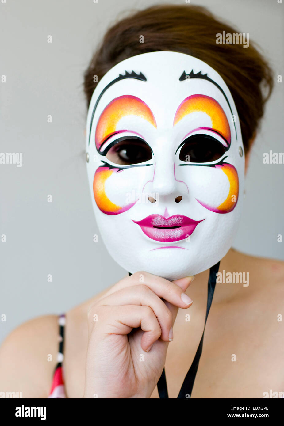 young woman behind mask Stock Photo - Alamy