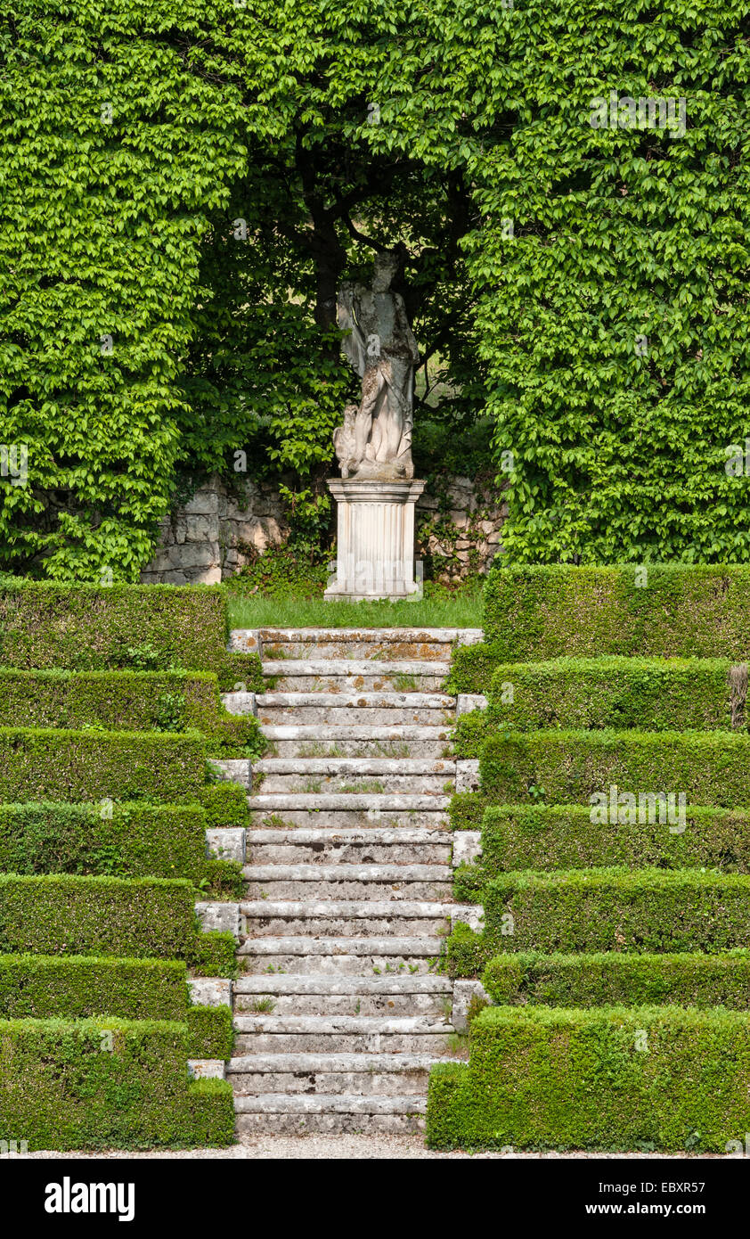 Immaculately clipped hedges of box and hornbeam form the 18c green ...