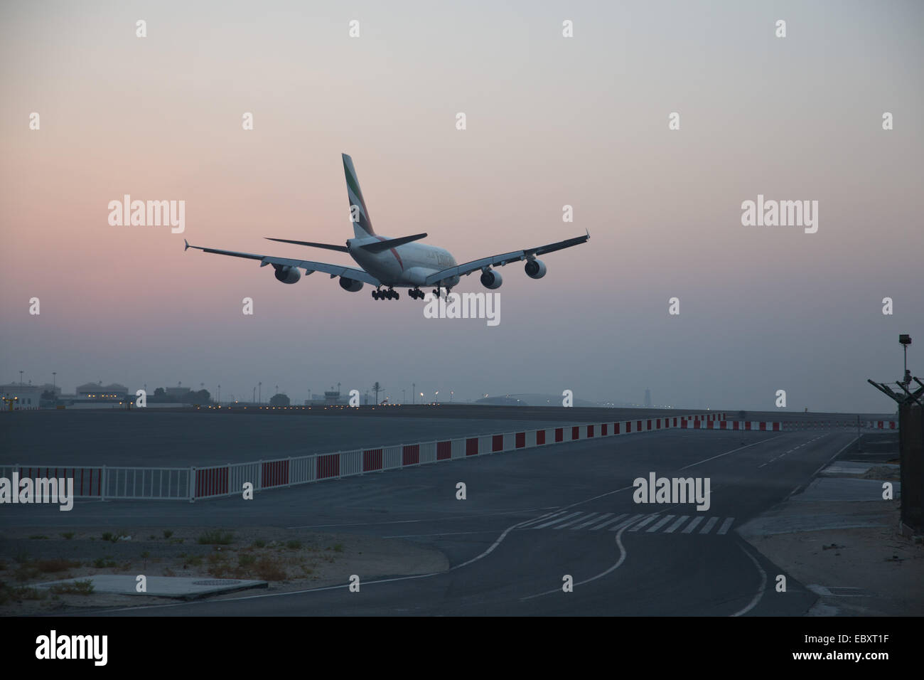 Plane coming into land on runway Stock Photo - Alamy