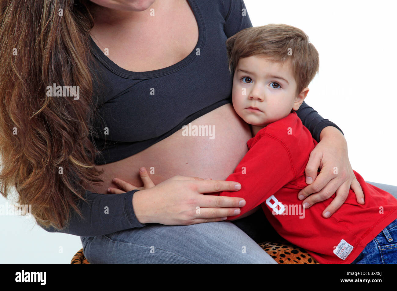little boy embracing the bare belly of her pregnant mother Stock Photo ...