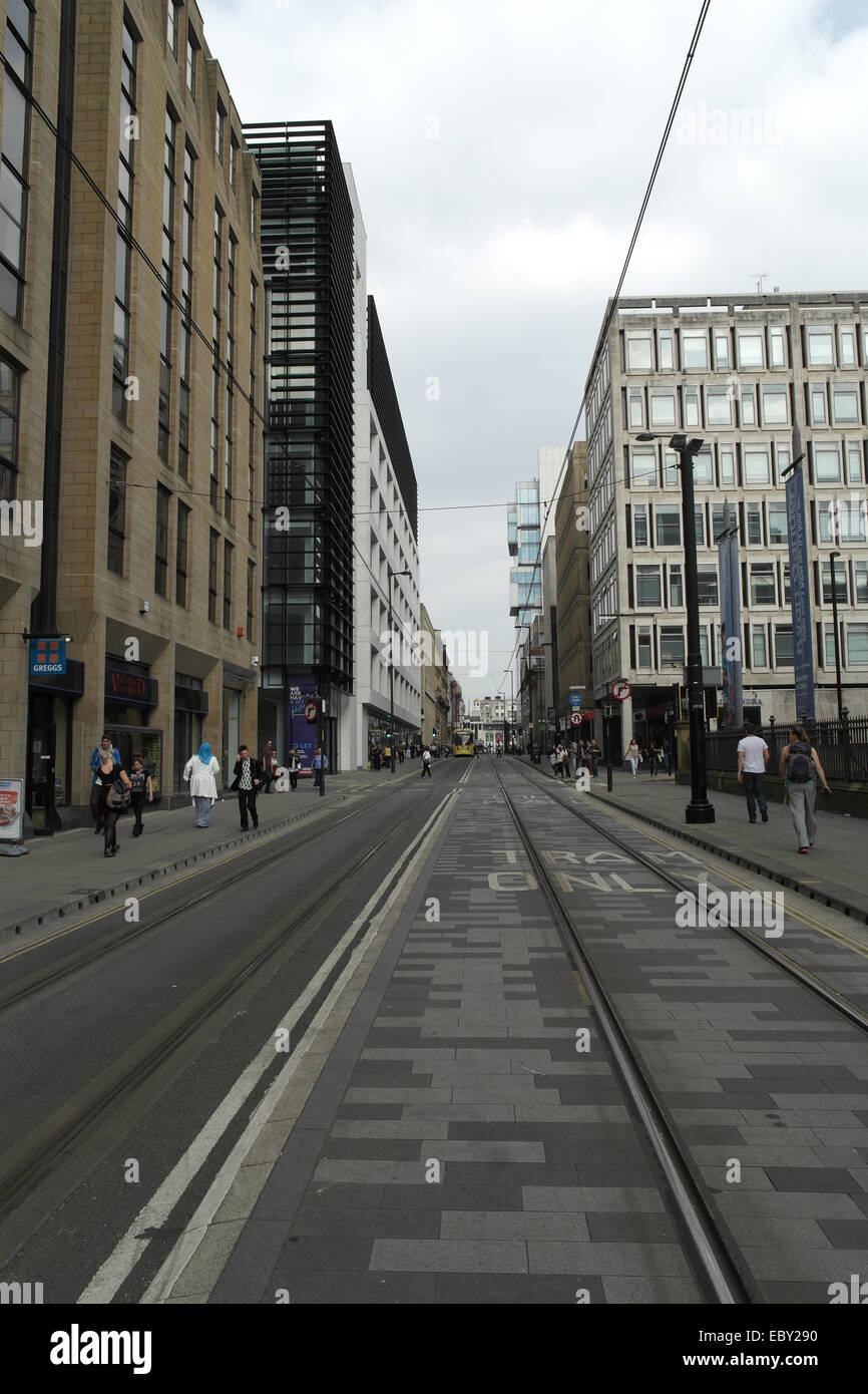White clouds portrait pavement people, buildings, Metrolink tram lines ...