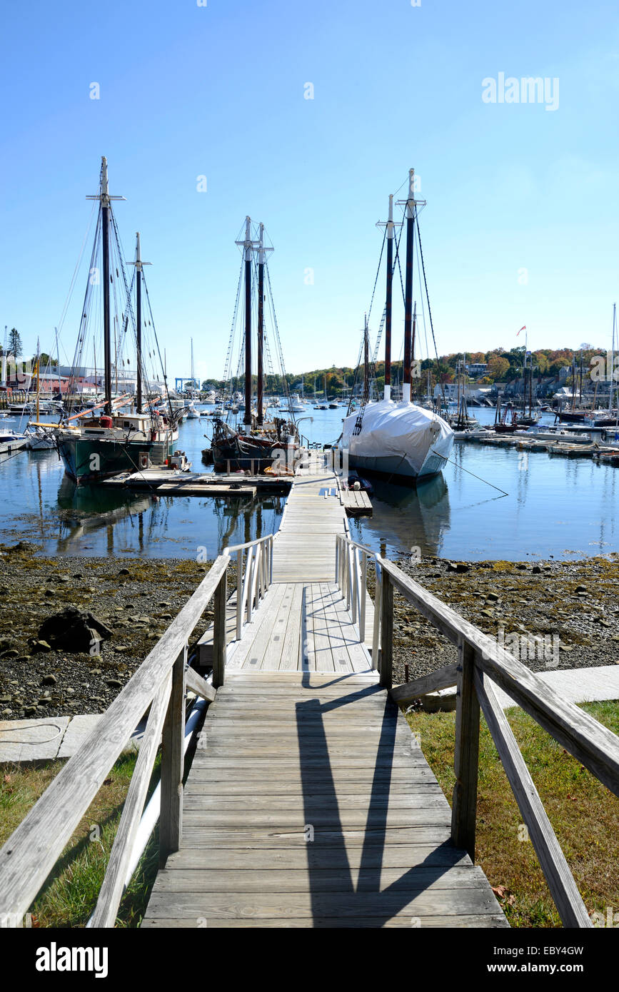 Long wooden dock that leads to the boats in the Camden Harbor in Maine ...