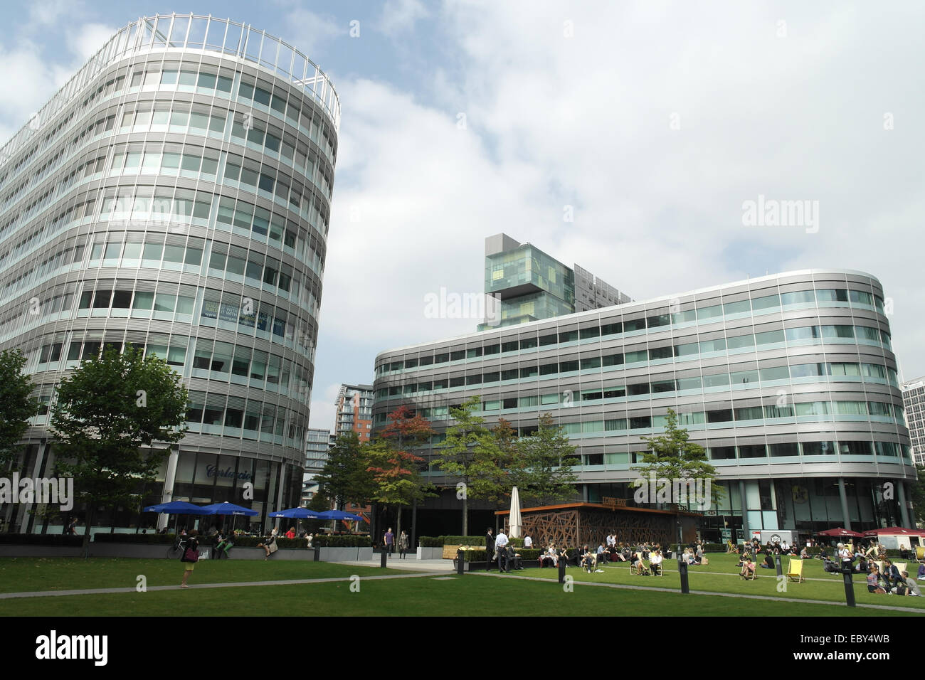 Blue sky white clouds across Hardman Square, with people relaxing deck ...