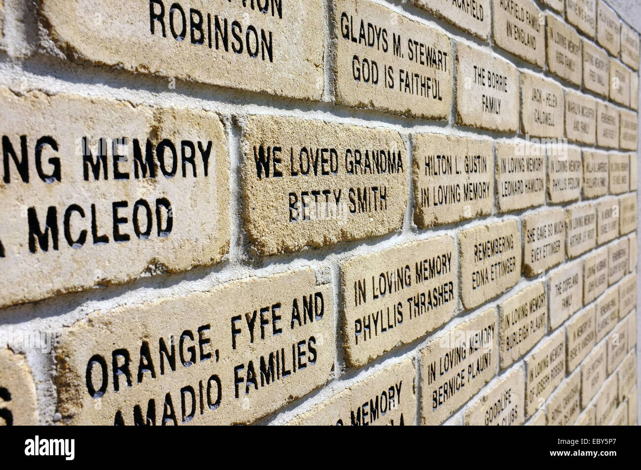 A brick wall with words carved into it Stock Photo - Alamy