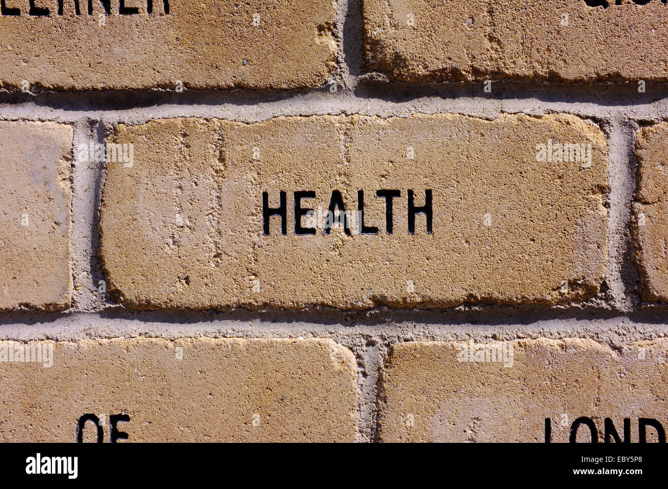 A brick with the word 'Health' carved into it Stock Photo - Alamy