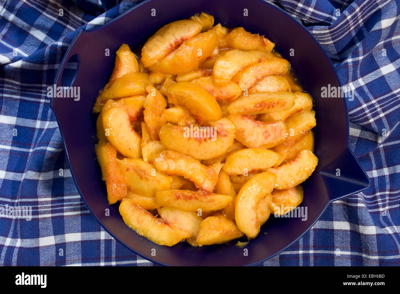Peeled peaches in a blue bowl Stock Photo - Alamy