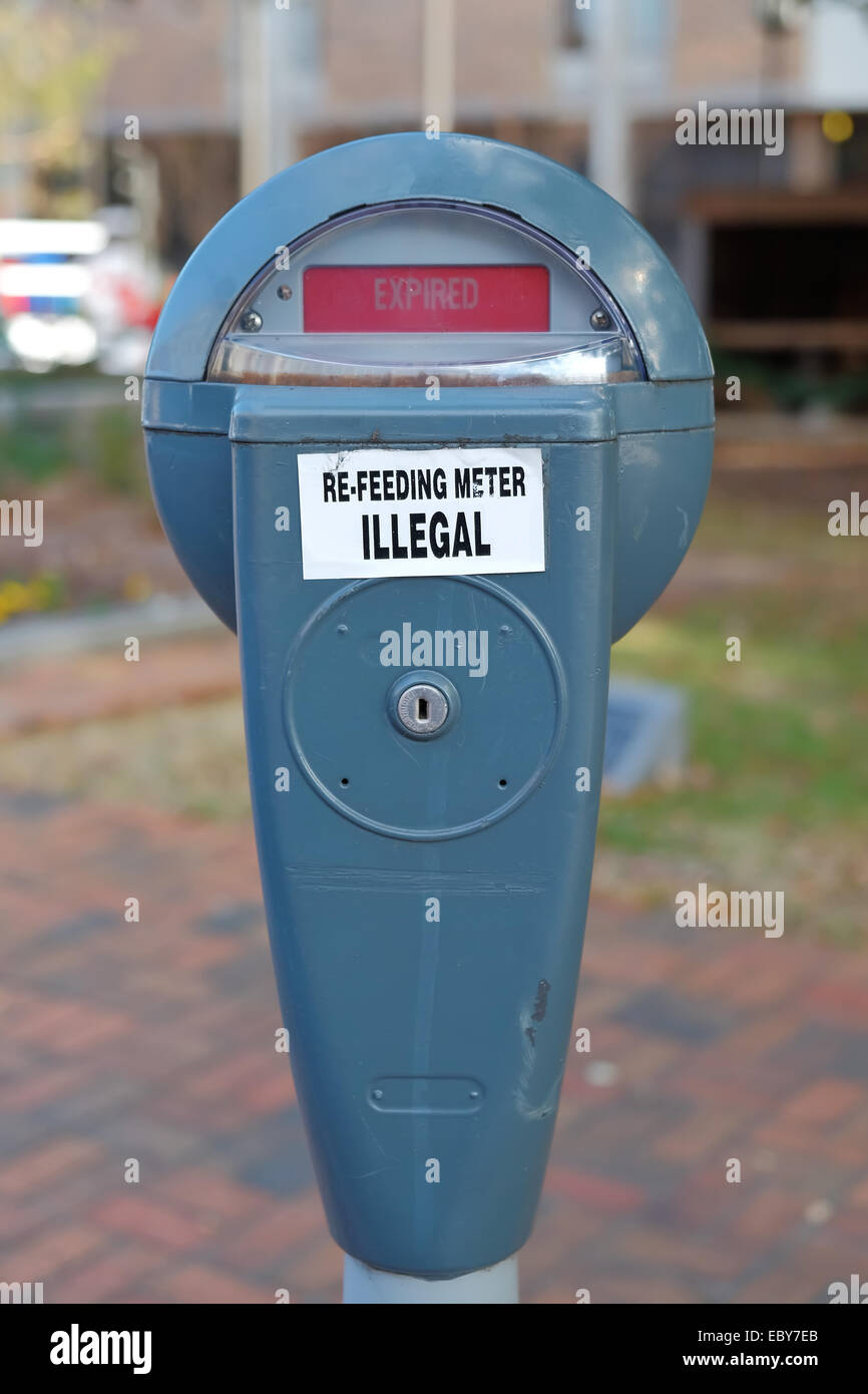 A parking meter in a downtown commercial area of the city showing ...