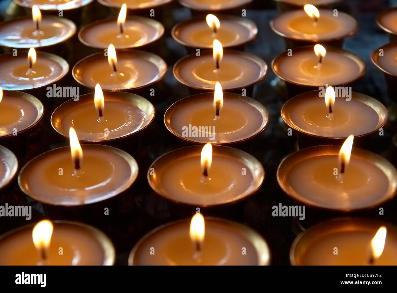 Rows of candles in the indian temple Stock Photo - Alamy