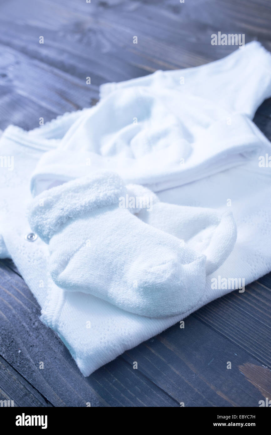 baby clothes on a table Stock Photo - Alamy