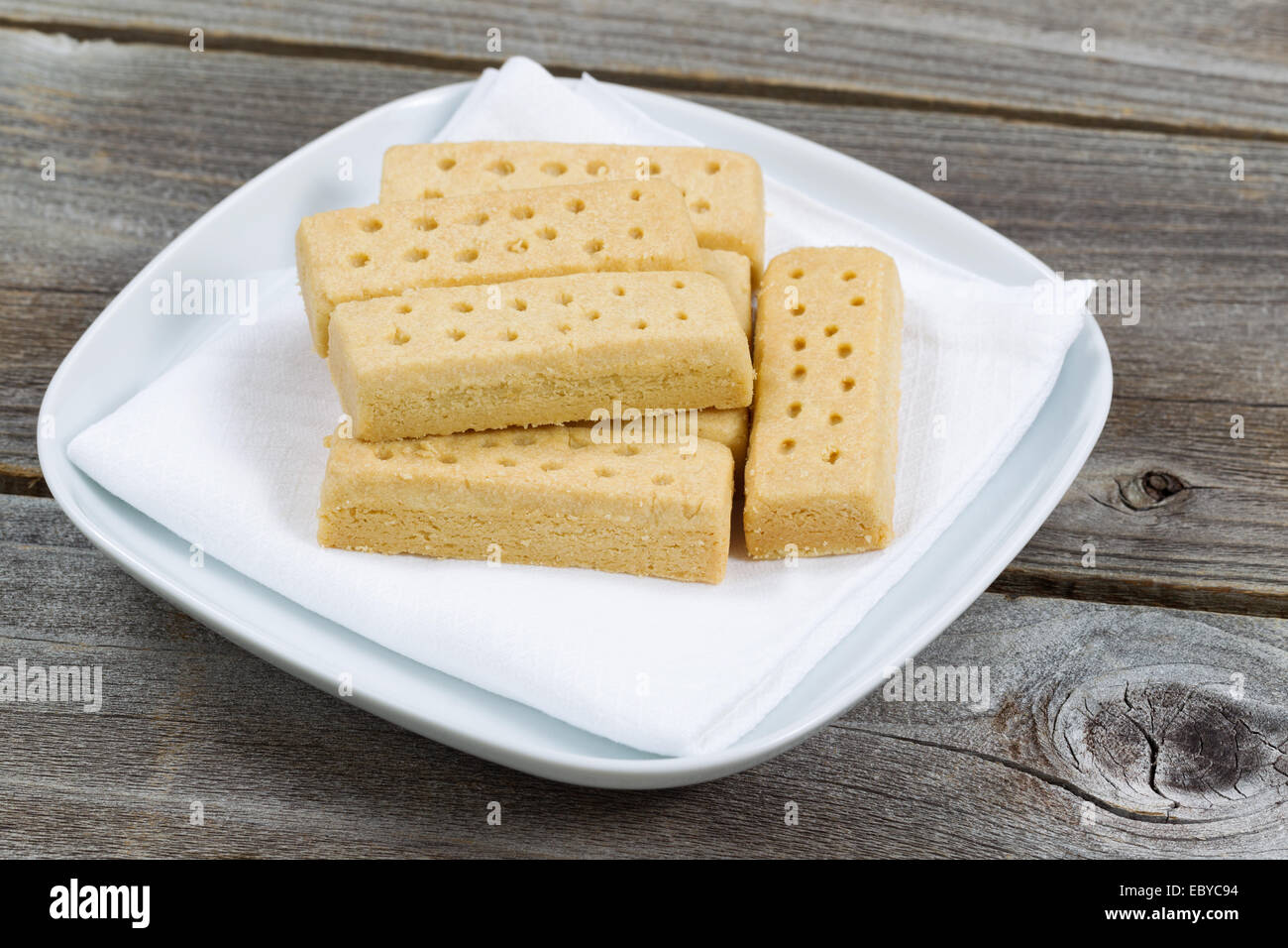 Close up horizontal image of butter cookies on white napkin and plate ...