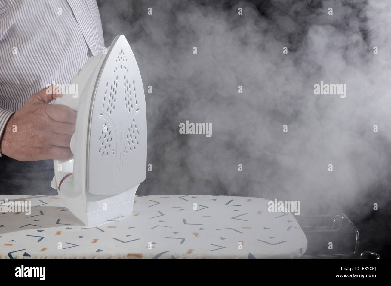 Hand gripping and iron and checking that it is hot enough Stock Photo ...