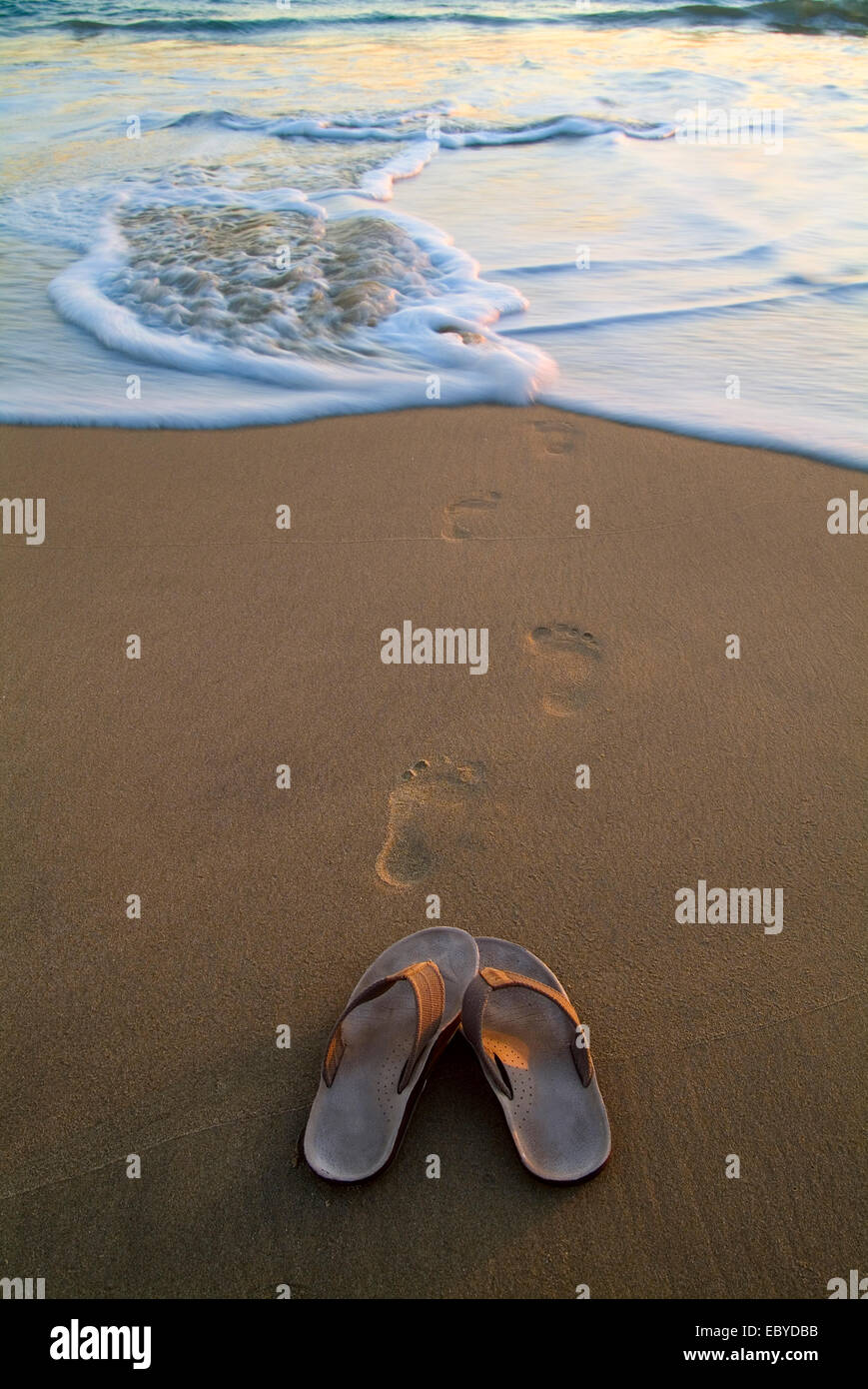 Sandals and Footprints on the Beach Stock Photo - Alamy