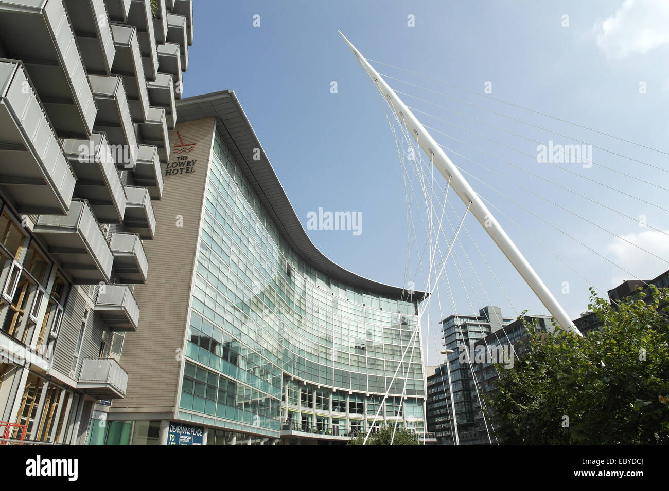 Blue sky view white pylon Trinity Footbridge, towards glass front Lowry ...