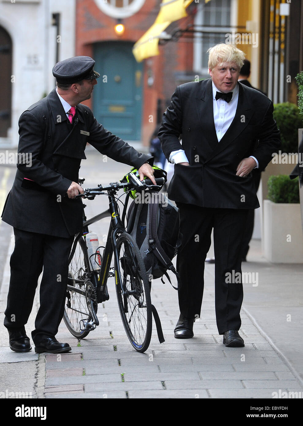 Boris Johnson arrives at May Fair Hotel riding on a bicycle Featuring ...