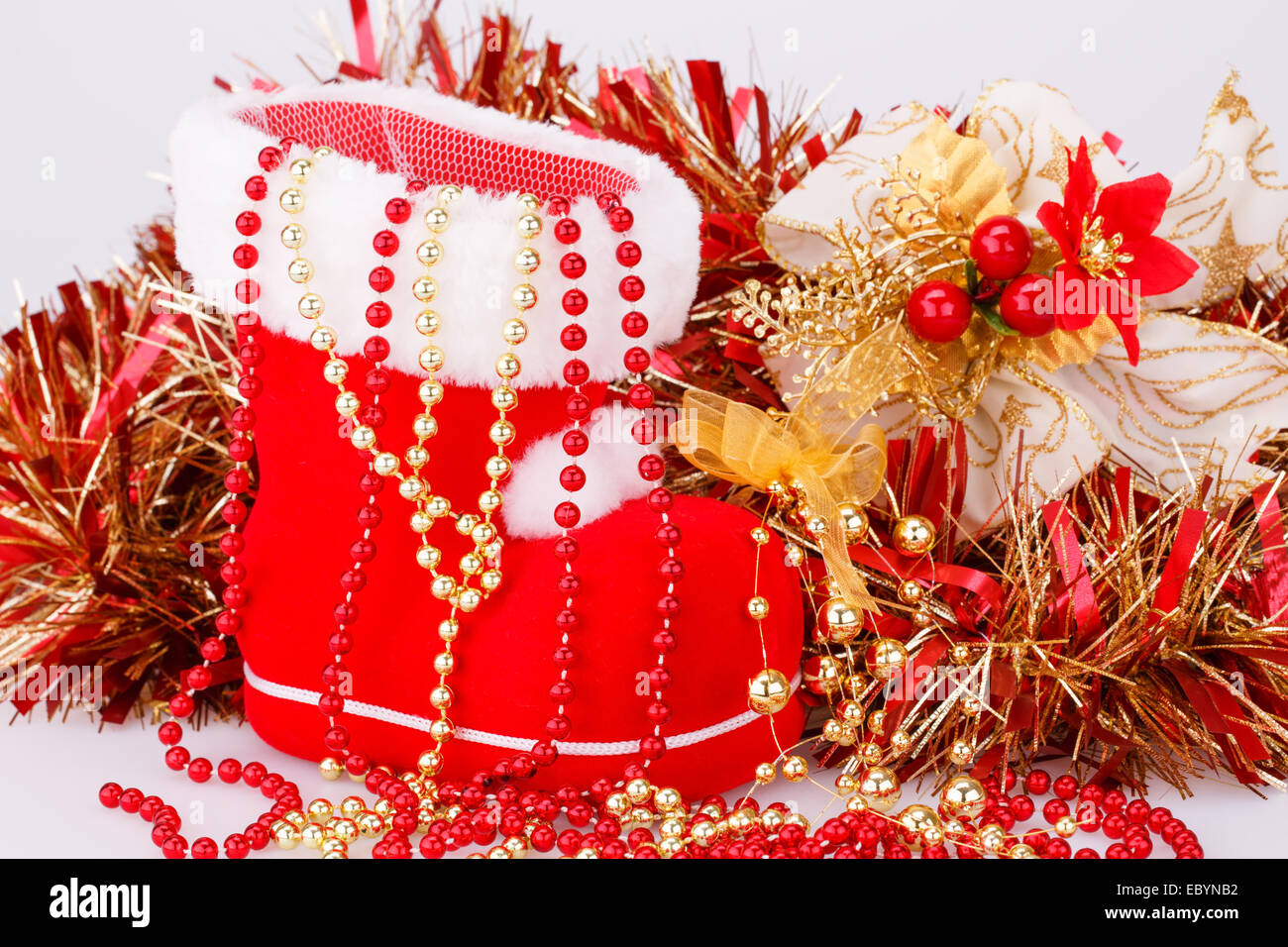 Christmas decoration with Santa's red boot, garland, beads closeup ...