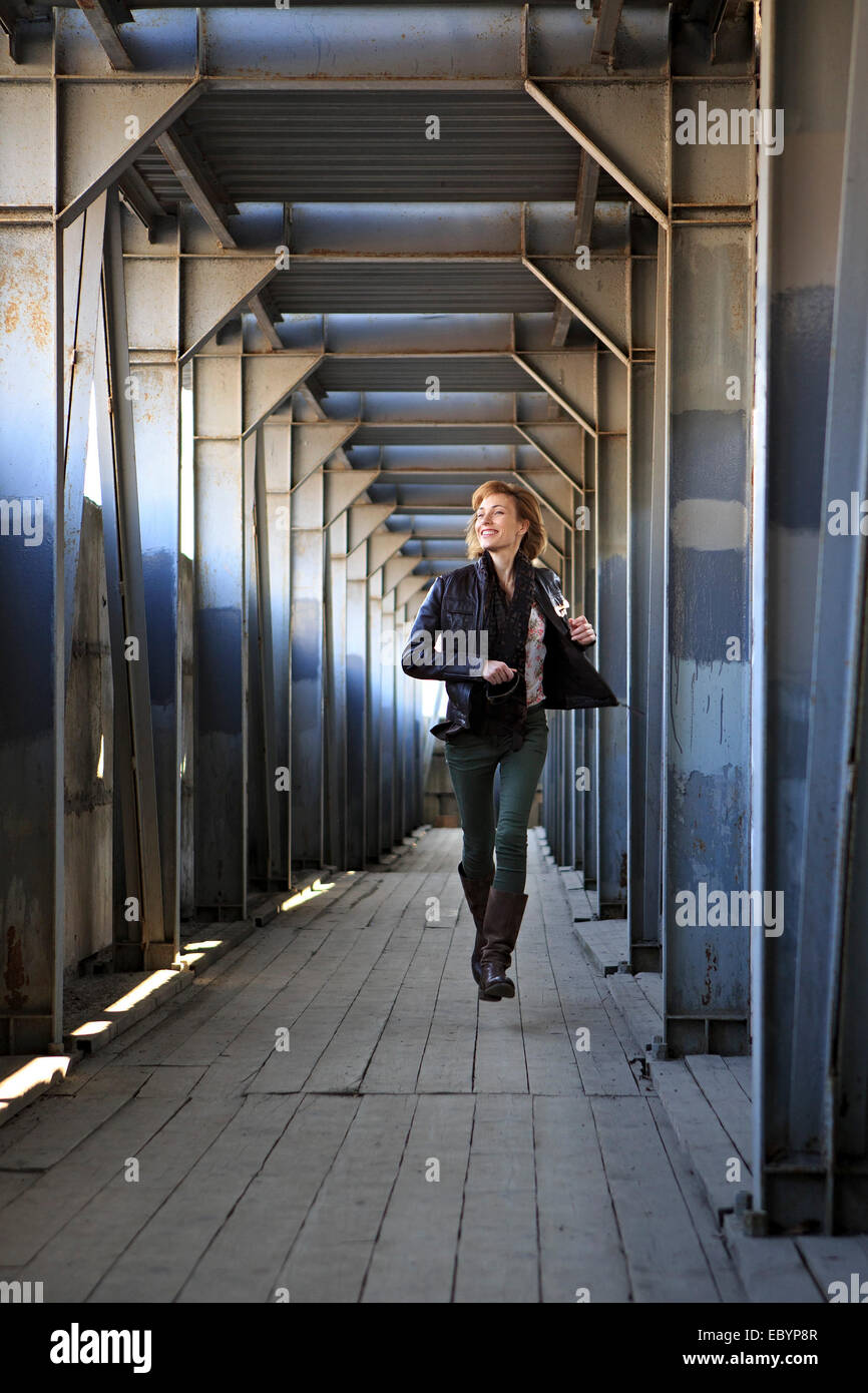 Beautiful girl running through the transition Stock Photo - Alamy