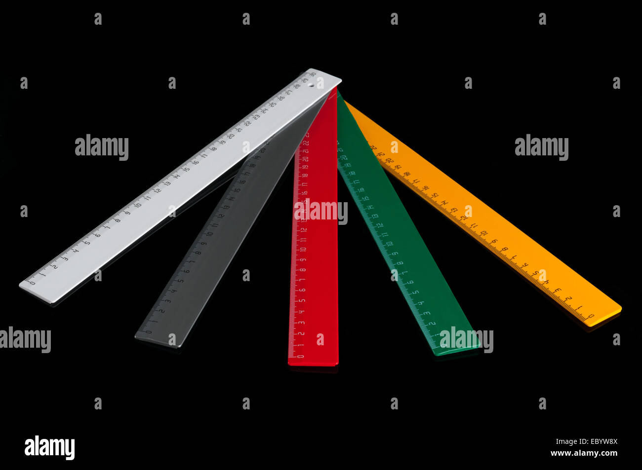 Five colorful rulers isolated on black background Stock Photo - Alamy
