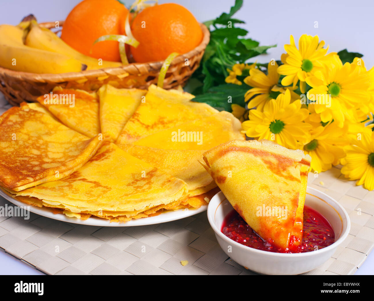 Pancake with raspberry jam decorated with fruits and flowers Stock ...