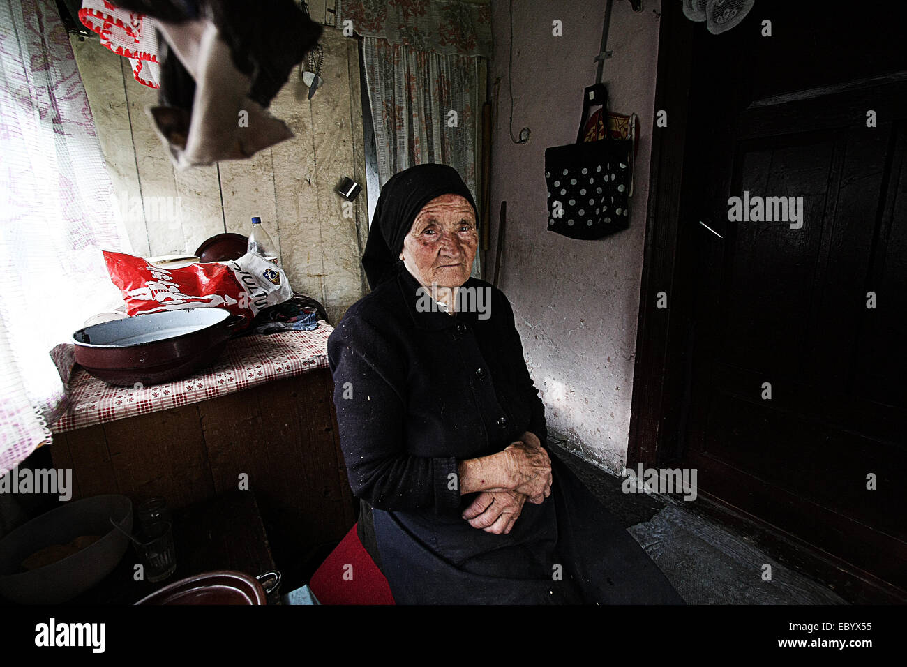 Elderly woman in her modest house in a village in the Apuseni mountains ...