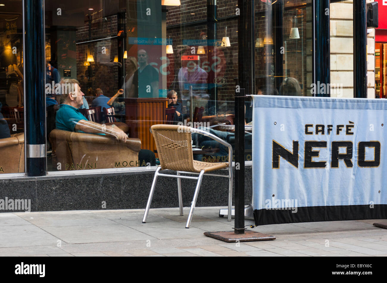 Middle aged man sitting inside a Cafe Nero coffee house Stock Photo - Alamy