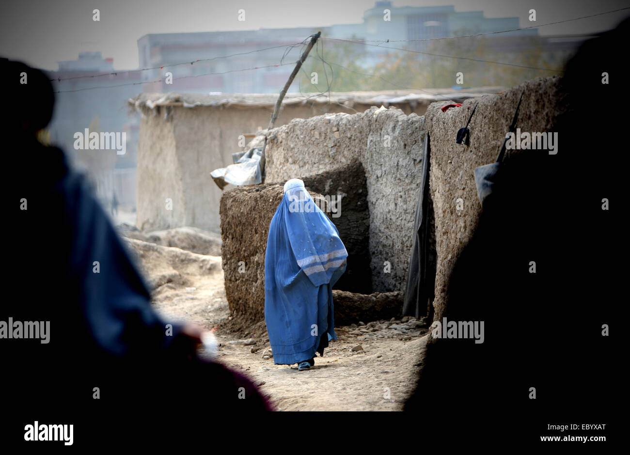 Kabul, Afghanistan. 2nd Dec, 2014. An Afghan woman walks at a slum area ...