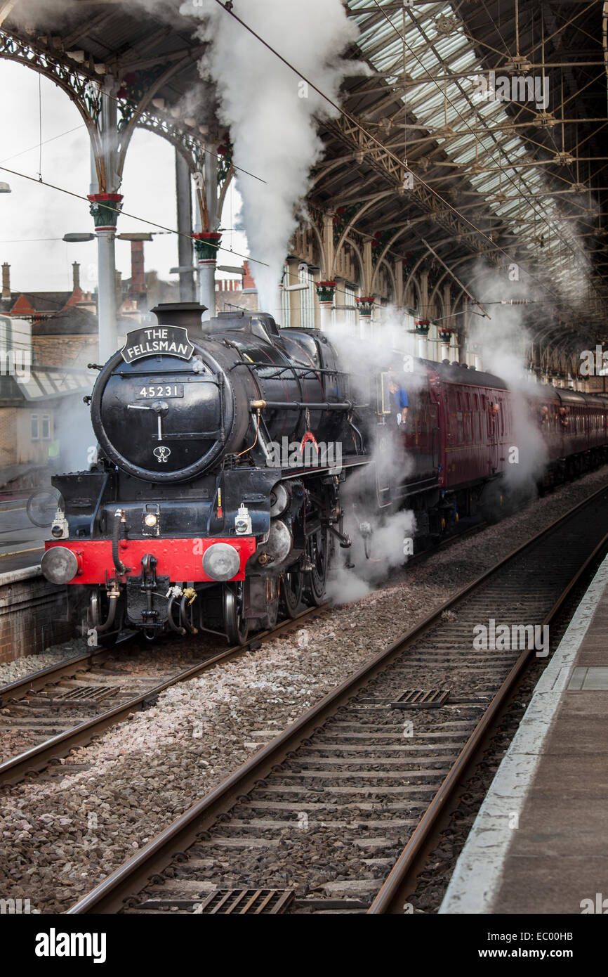 Steam train leaving station Stock Photo - Alamy
