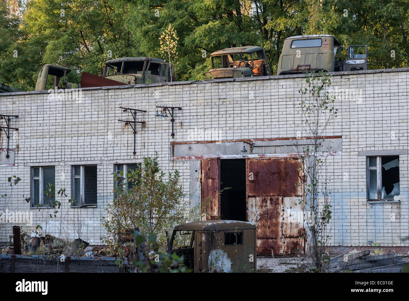 Liquidators vehicles on building roof next to Police Station in Pripyat ...