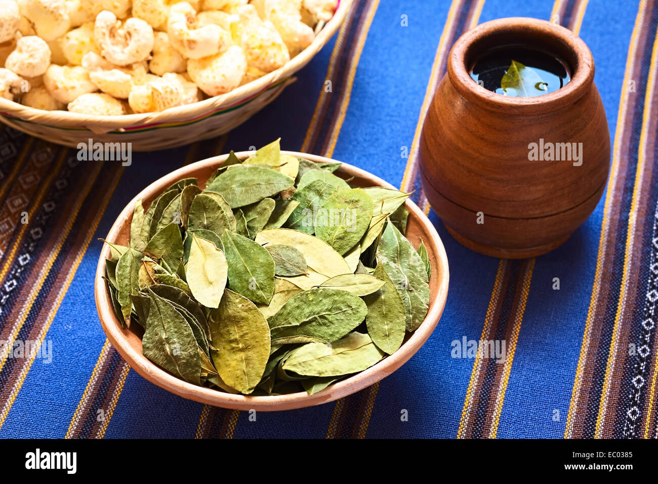 Dried coca leaves in clay bowl with fresh coca tea (mate de coca) on ...