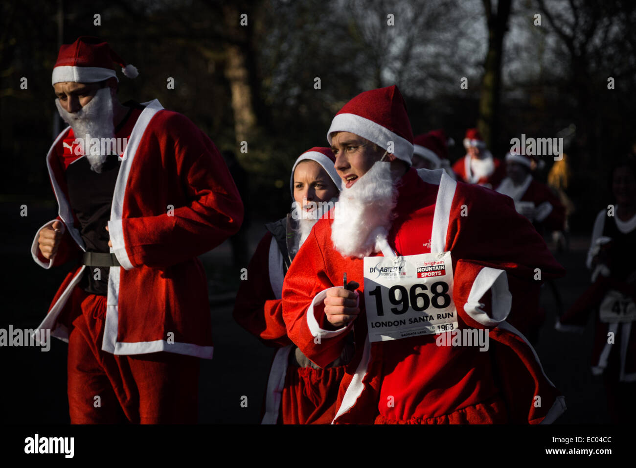London, UK. 6th Dec, 2014. Annual Charity Santa Run in Battersea Park ...
