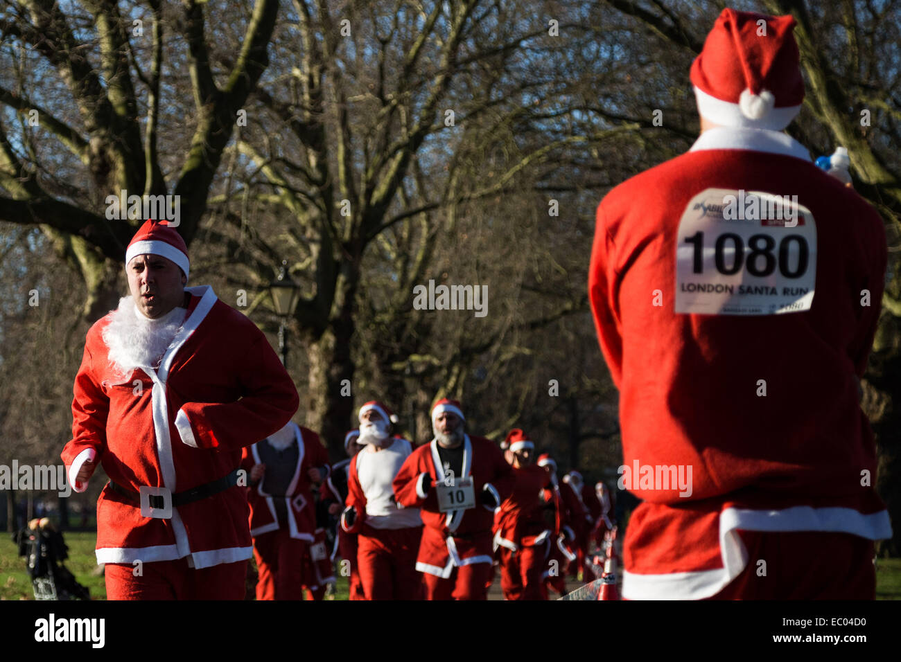 London, UK. 6th Dec, 2014. Annual Charity Santa Run in Battersea Park ...