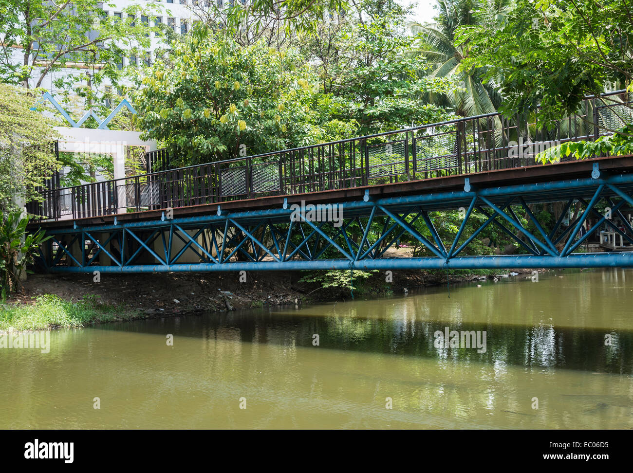 Modern steel bridge crossing the canal in urban park Stock Photo - Alamy