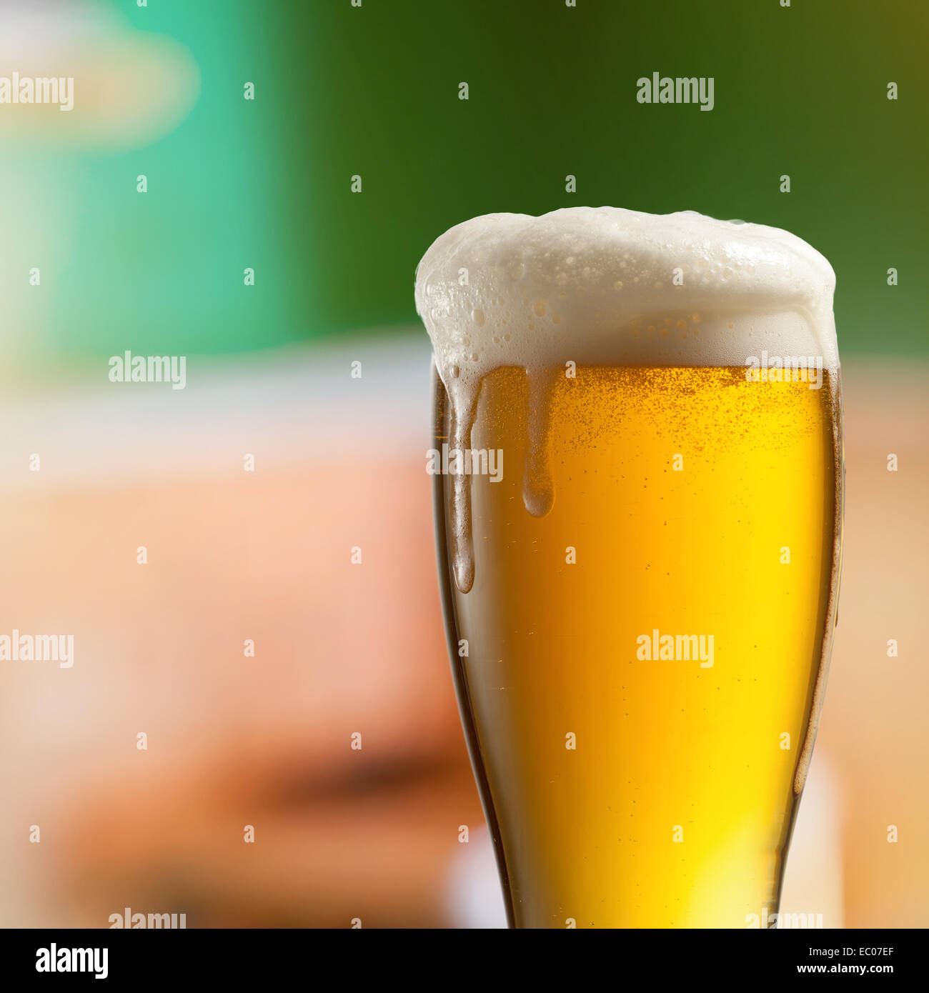 Glass of light beer in pub Stock Photo - Alamy
