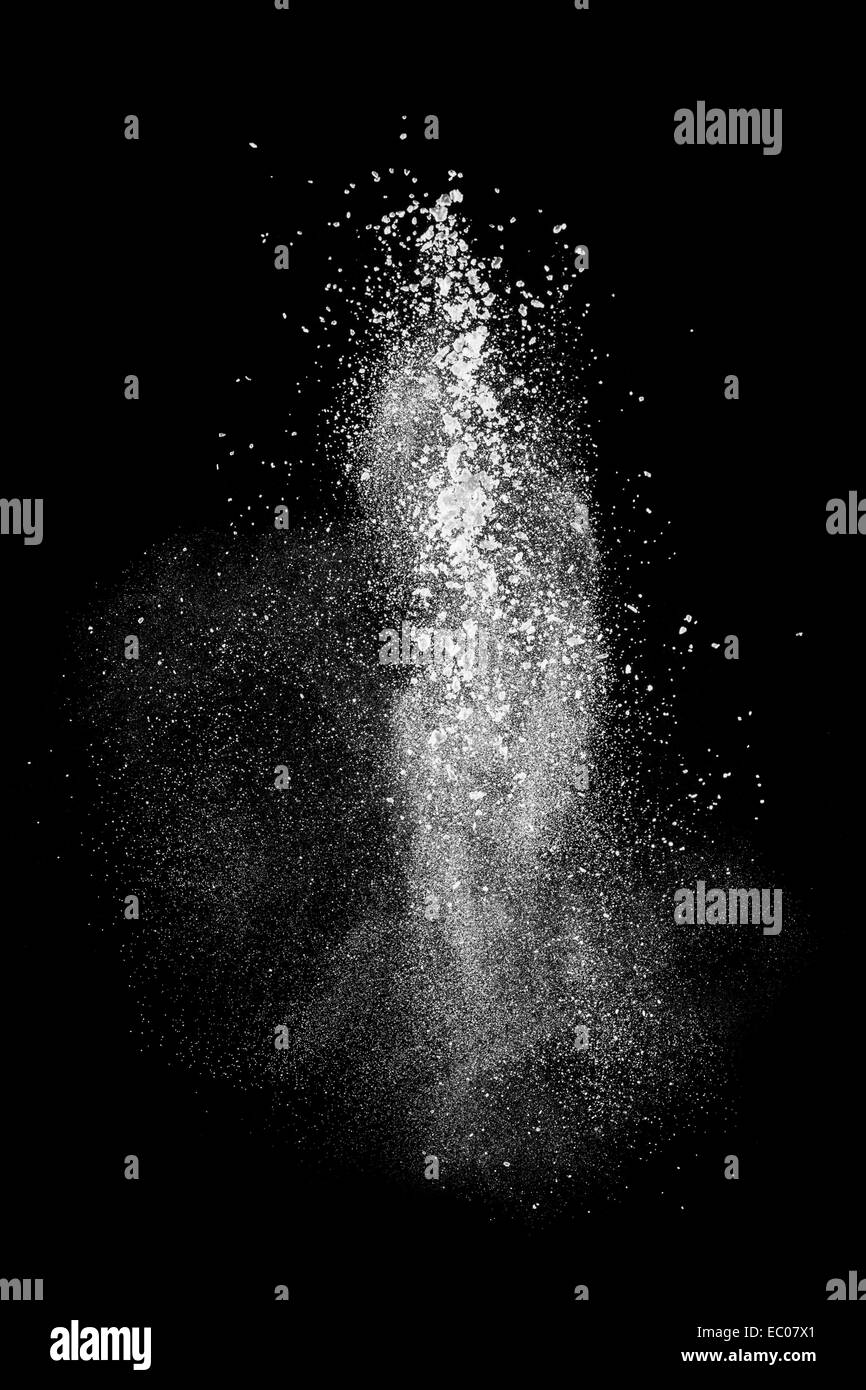 White powder explosion isolated on black background Stock Photo - Alamy