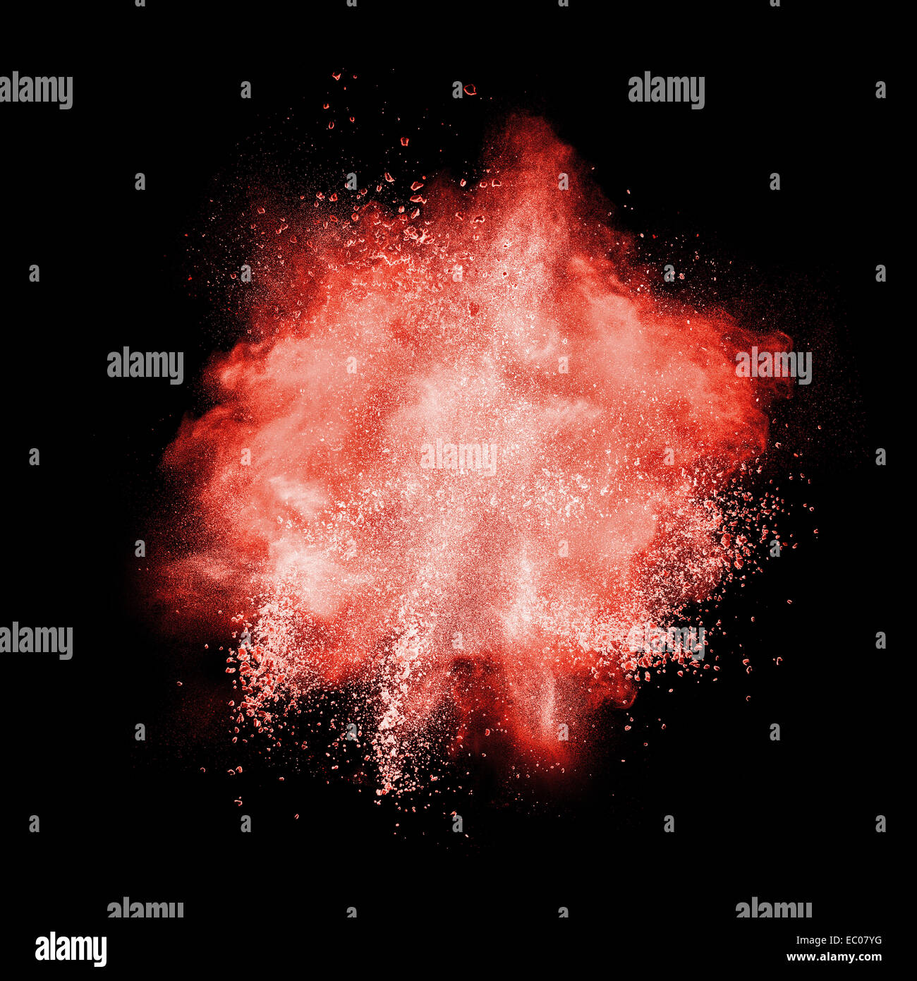 Red powder explosion isolated on black background Stock Photo - Alamy