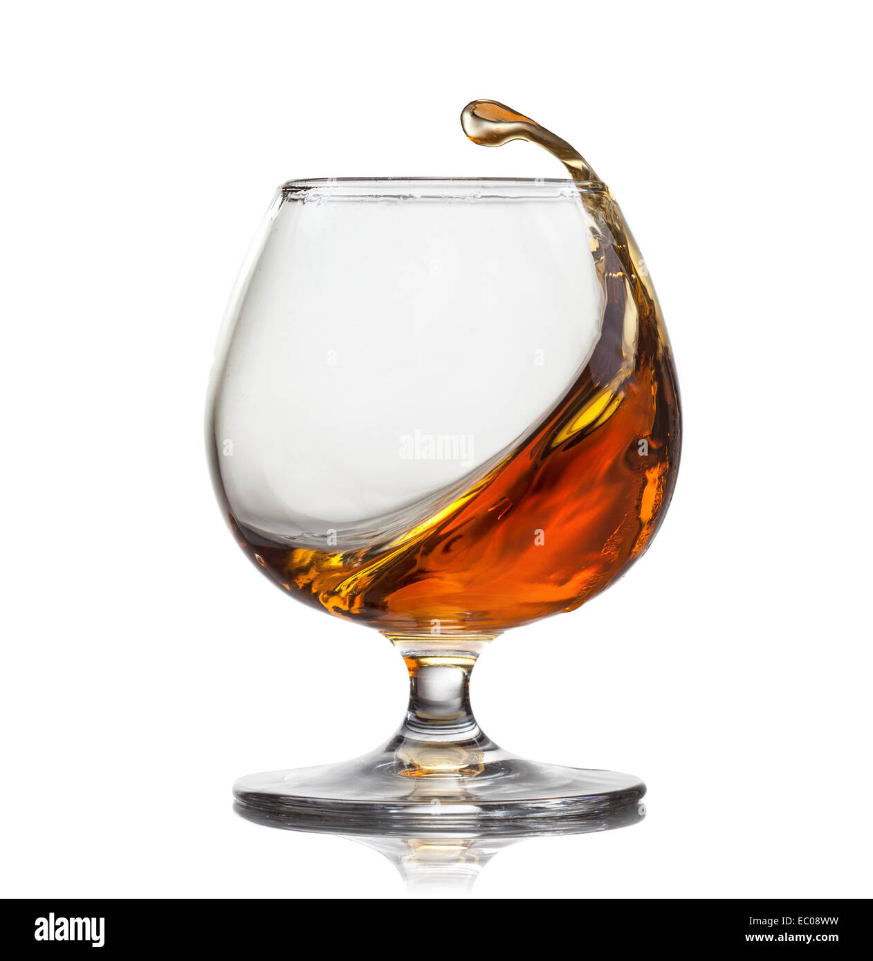 Splash of cognac in glass isolated on white background Stock Photo - Alamy