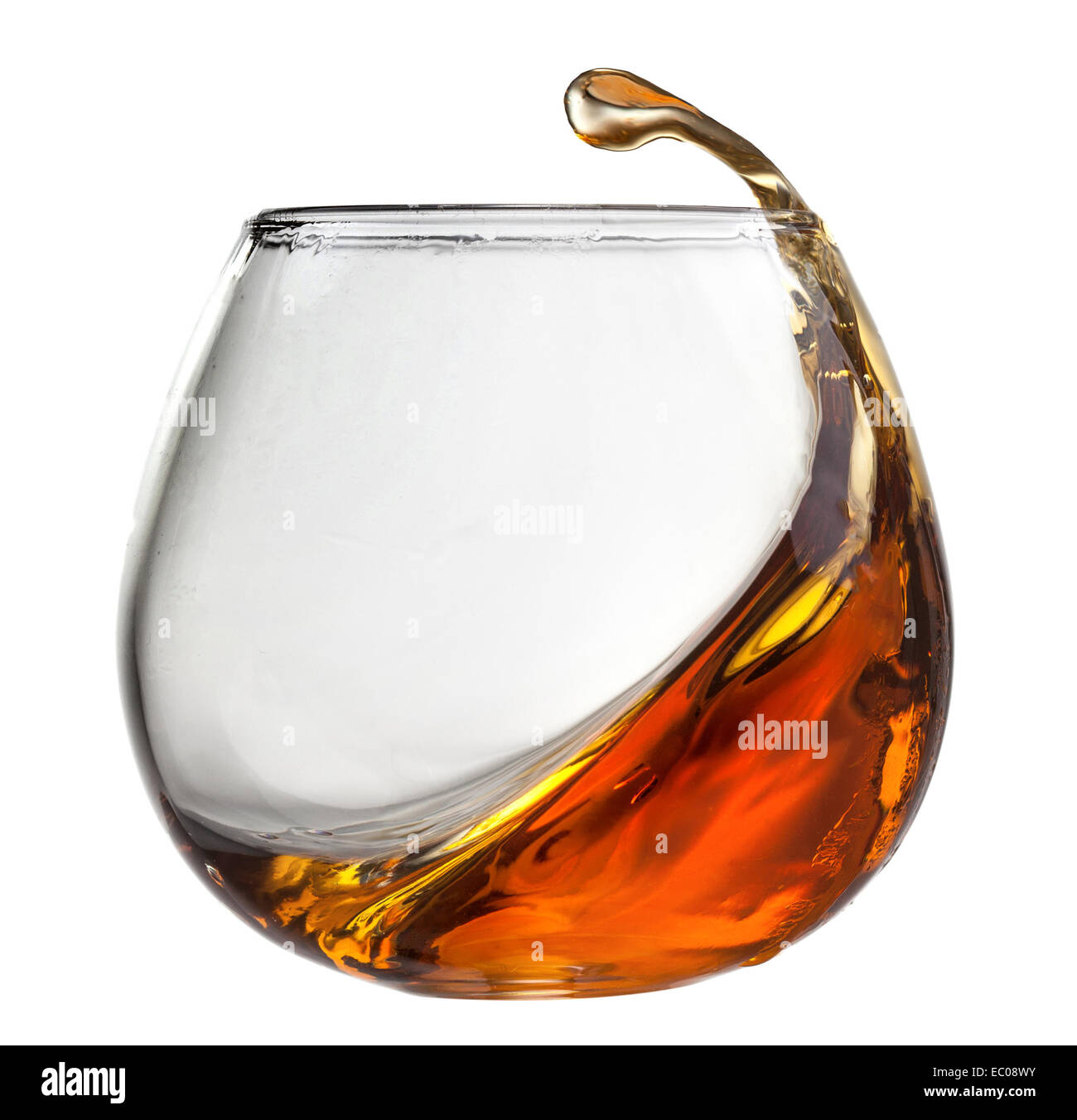 Splash of cognac in glass isolated on white background Stock Photo - Alamy