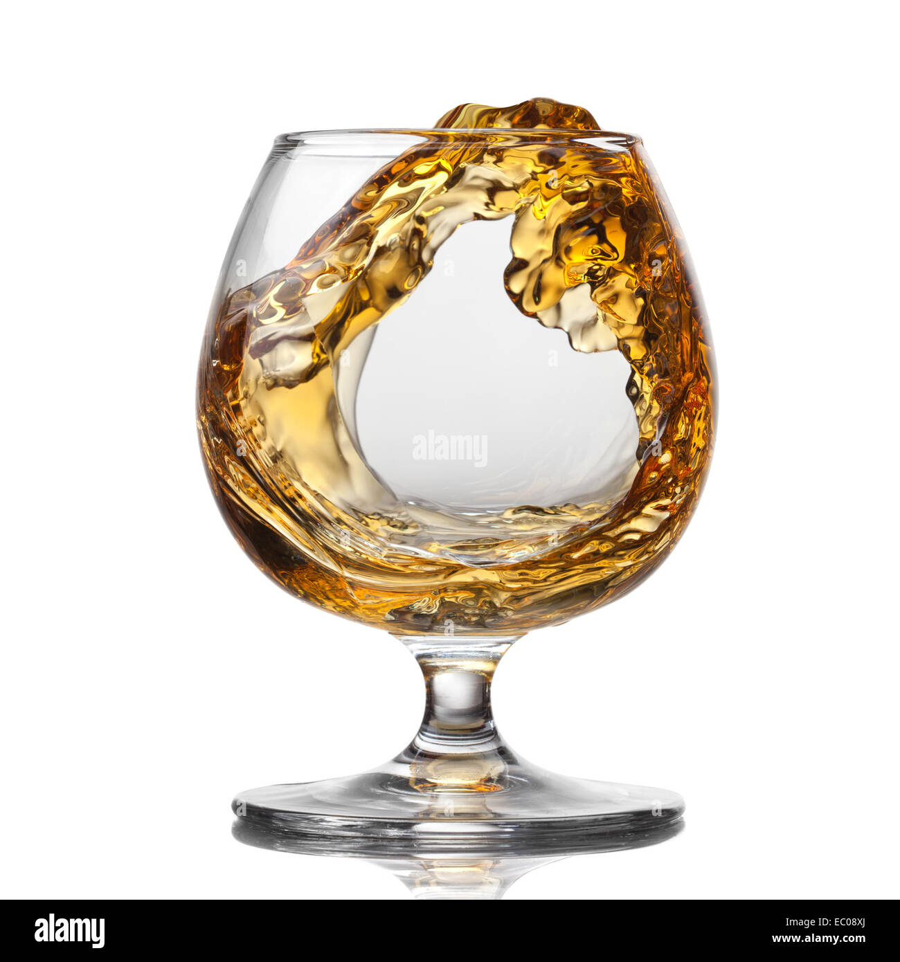 Splash of cognac in glass isolated on white background Stock Photo - Alamy