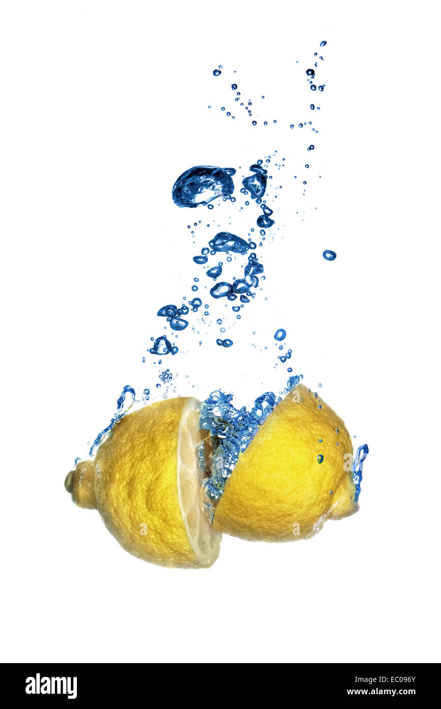 Fresh lemon dropped into water with bubbles isolated on white Stock ...